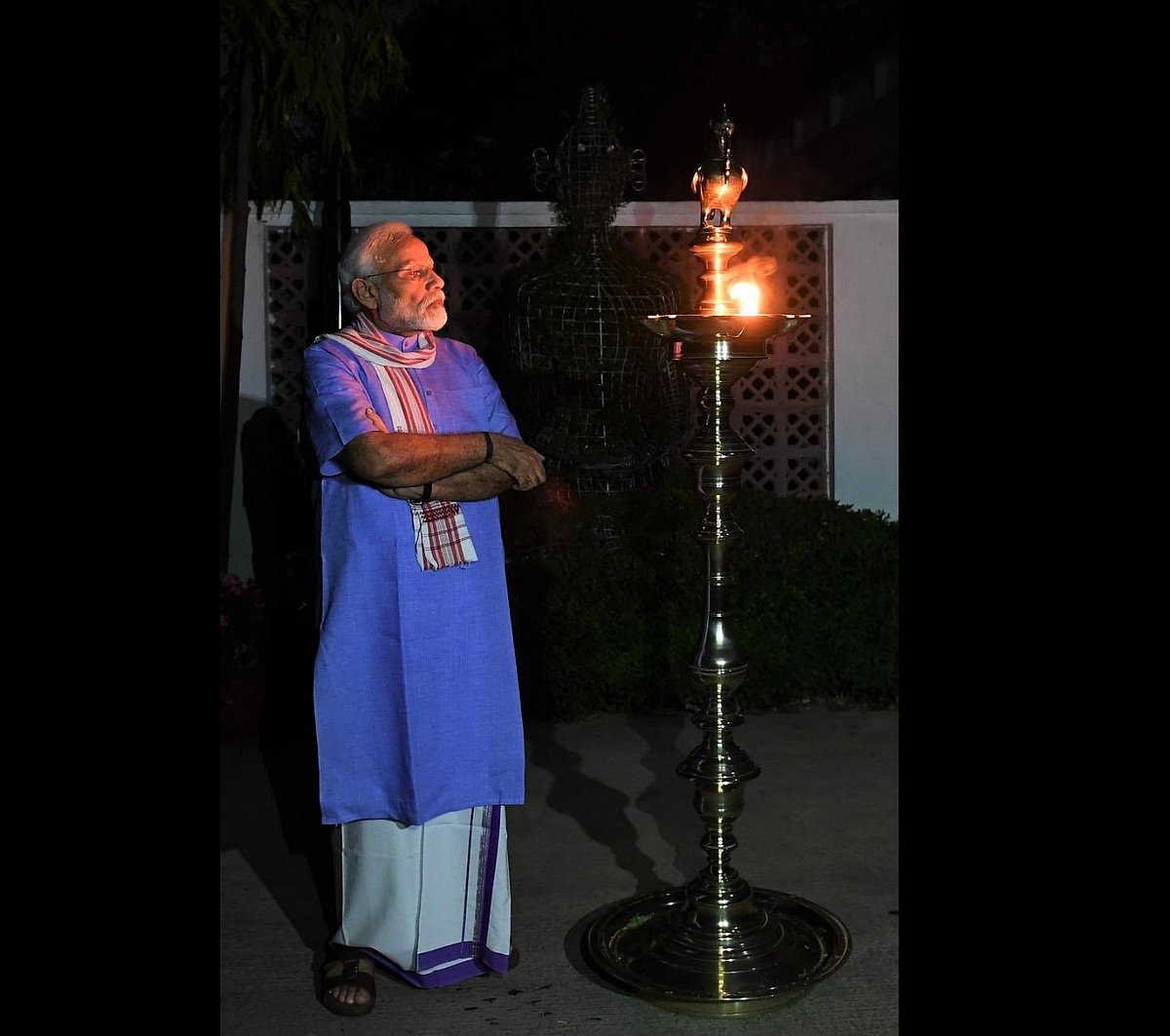 Lord of Light? PM Modi's strikes a pose as he lights a lamp in darkness ...